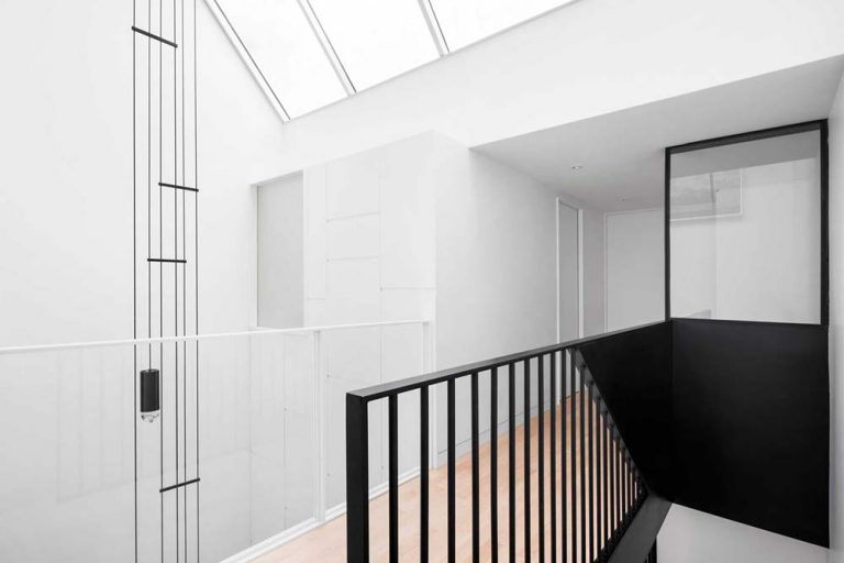 Row House Renovated With Modern Interiors and Triple Height Space